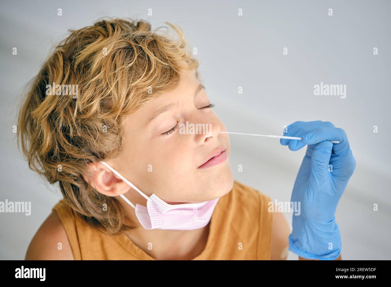 Crop unrecognizable medic in sterile glove with swab taking COVID 19 ...