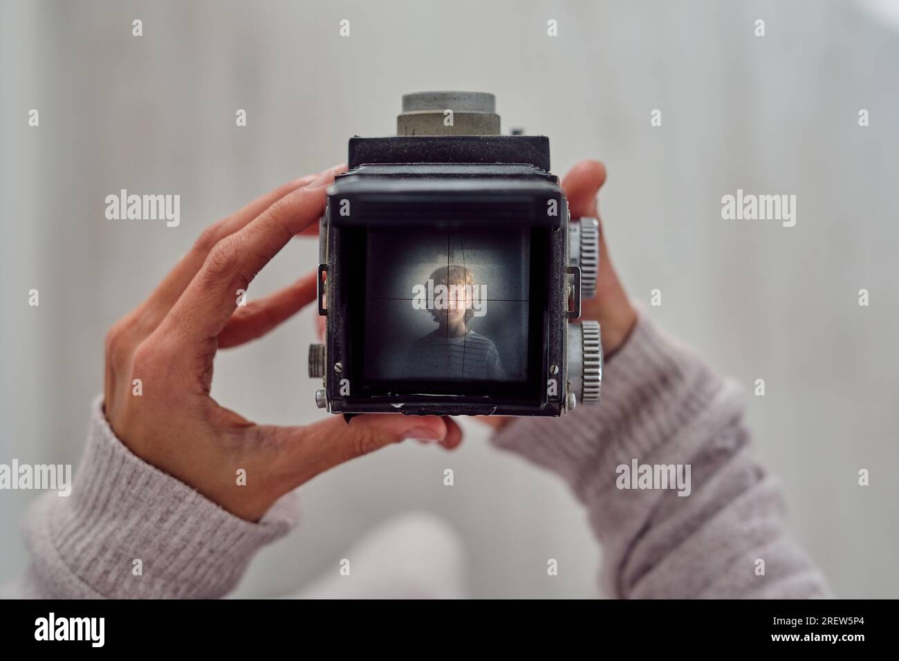 Crop unrecognizable person showing photography of child on vintage ...