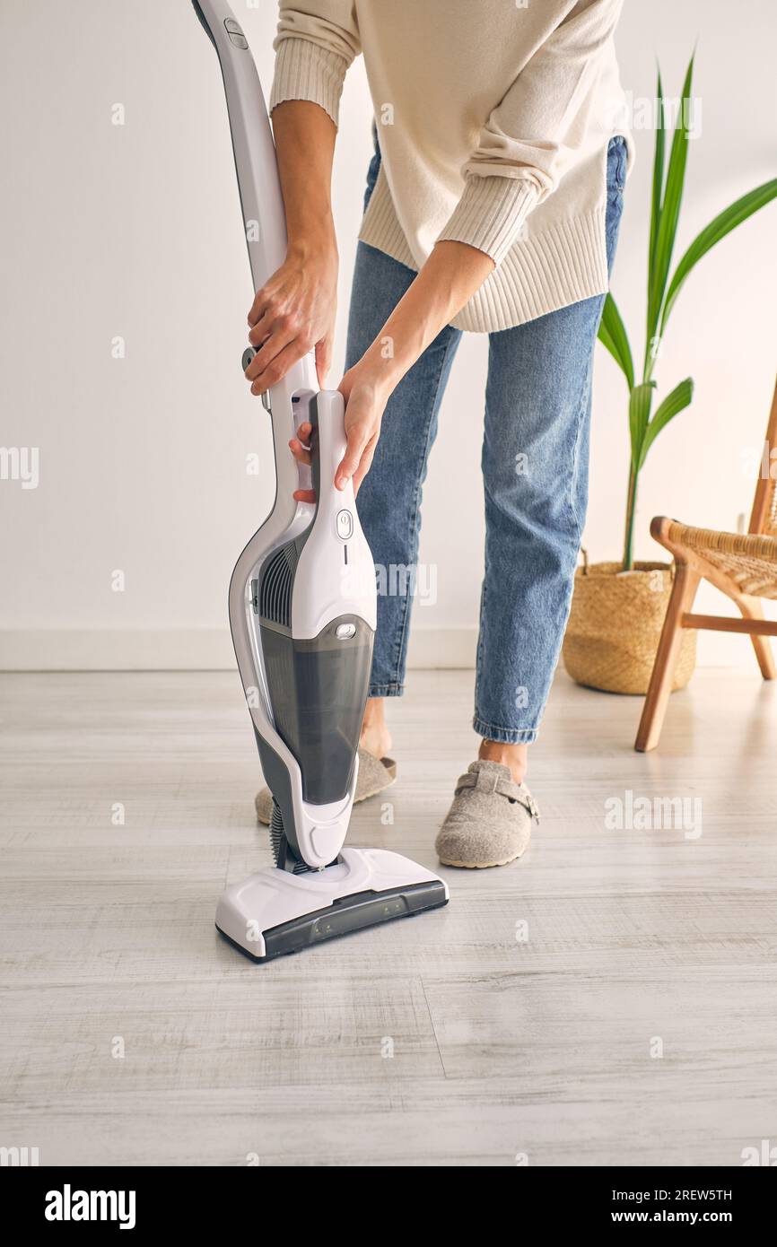 Crop unrecognizable female in casual clothes and slipper removing ...