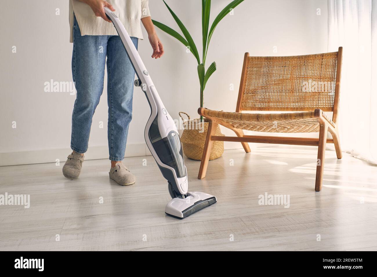 Side view of crop faceless housewife in casual outfit and slippers ...