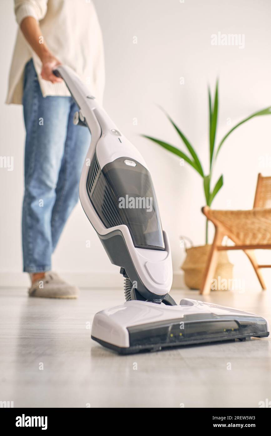 Side view of crop faceless housewife in casual outfit and slippers ...