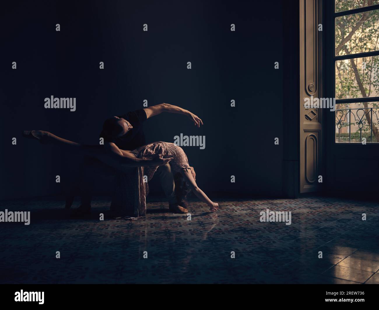 Full body of flexible ballerina in dress lying on knees of male dancer ...