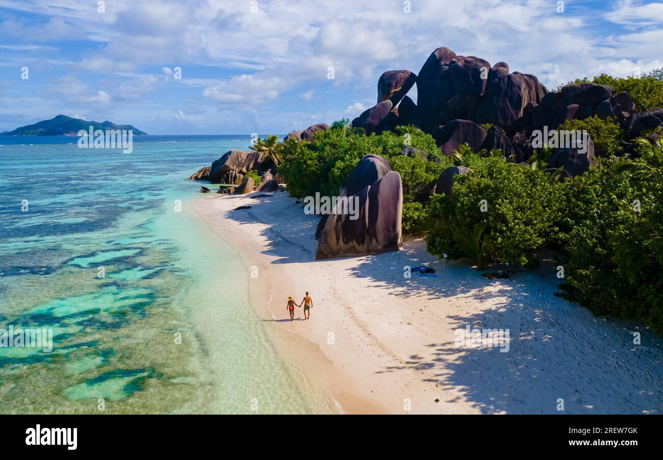 Anse Source d'Argent, La Digue Seychelles, a young couple of men and ...