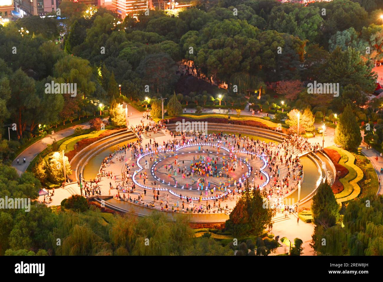KORLA, CHINA - JULY 28, 2023 - People cool off in front of a music ...