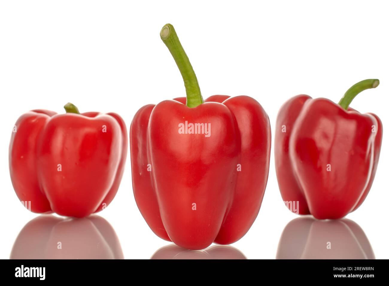 Three red bell peppers, macro, isolated on white background Stock Photo ...