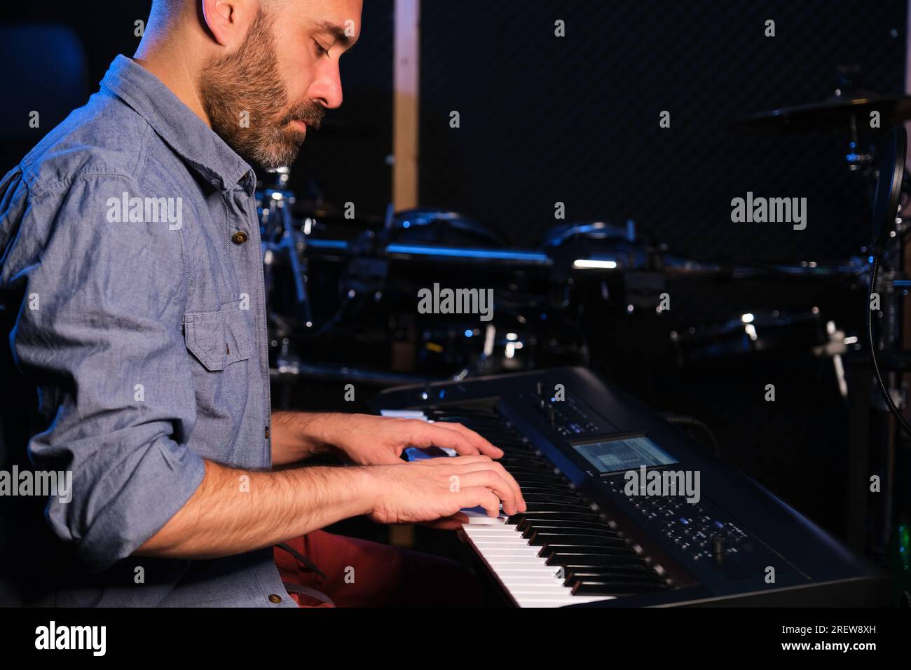 Musician man playing the electric piano in a recording studio Stock ...
