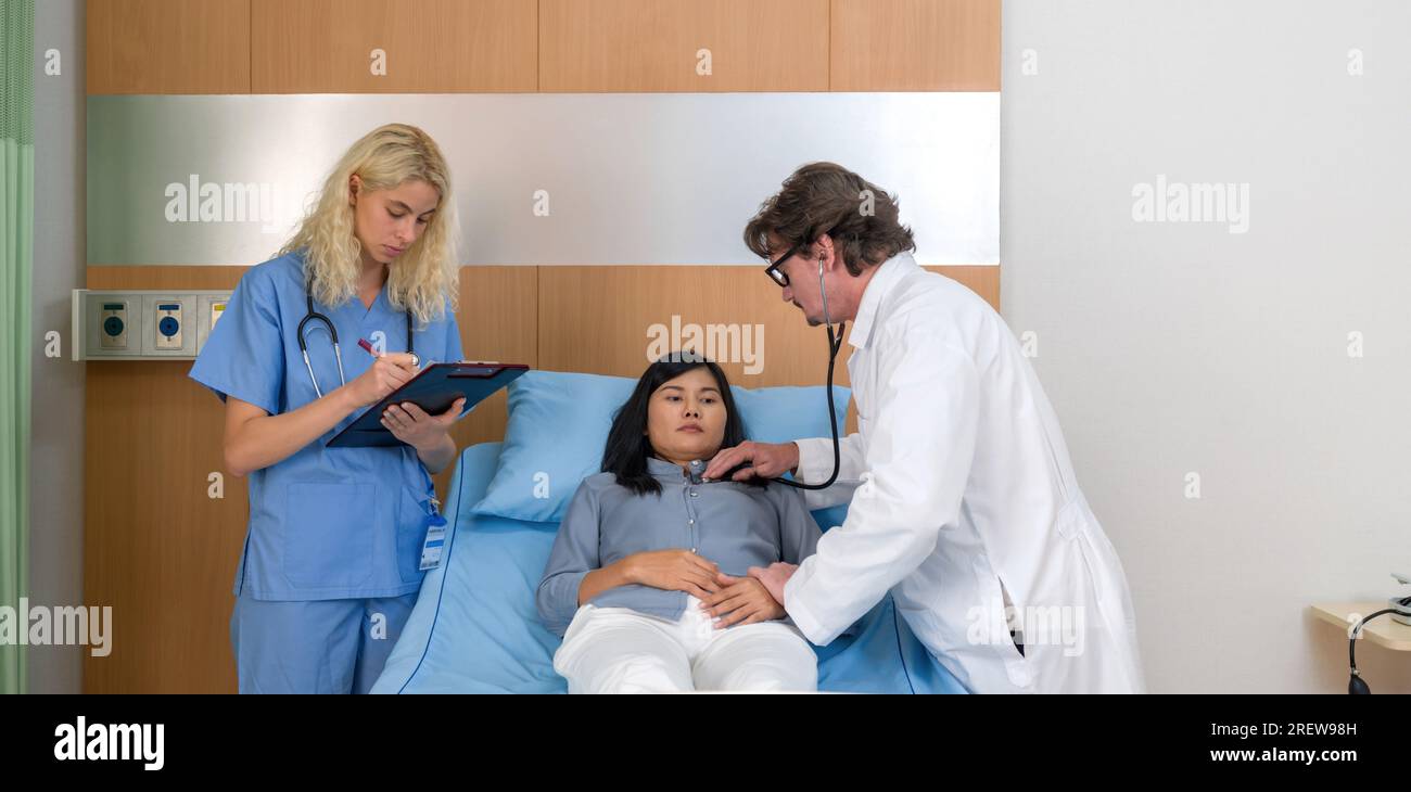 Compassionate doctor engaged in conversation with patient reclining on ...