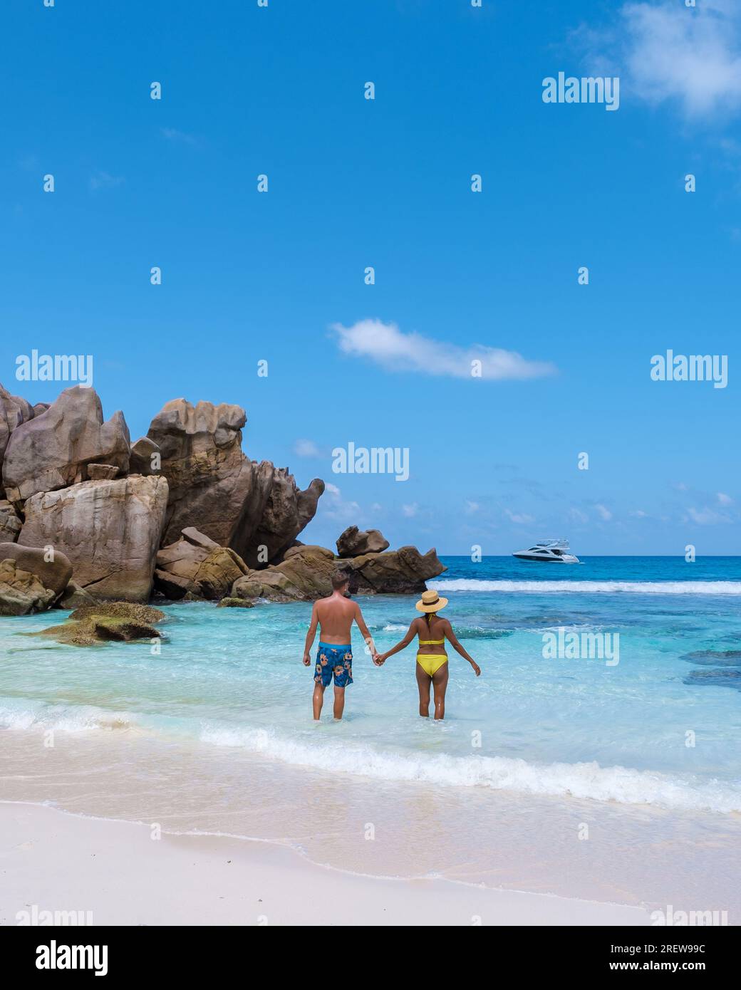 Anse Cocos La Digue Seychelles, a young couple of men and women on a ...