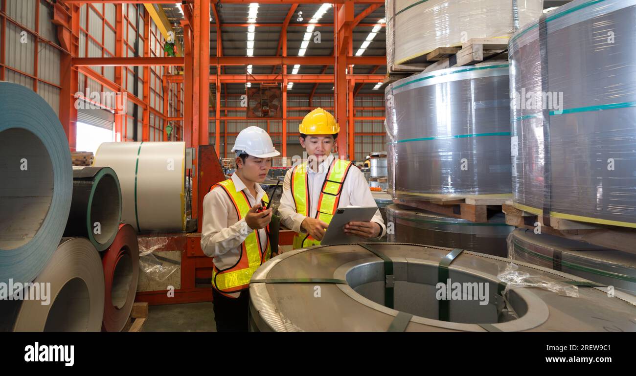 Industrial warehouse scene featuring two safety-conscious men ...