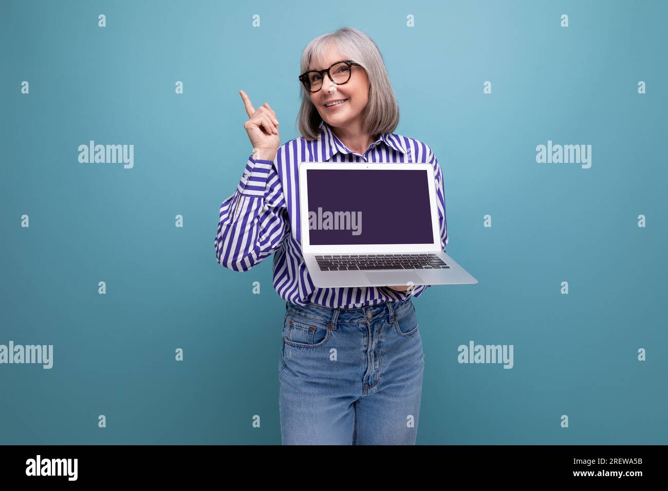 middle aged woman mastering laptop with mockup on bright studio ...