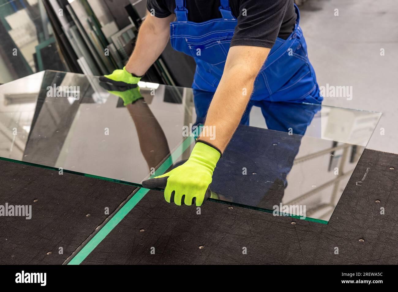 The glazier places the glass top on a specialized glass cutting table ...