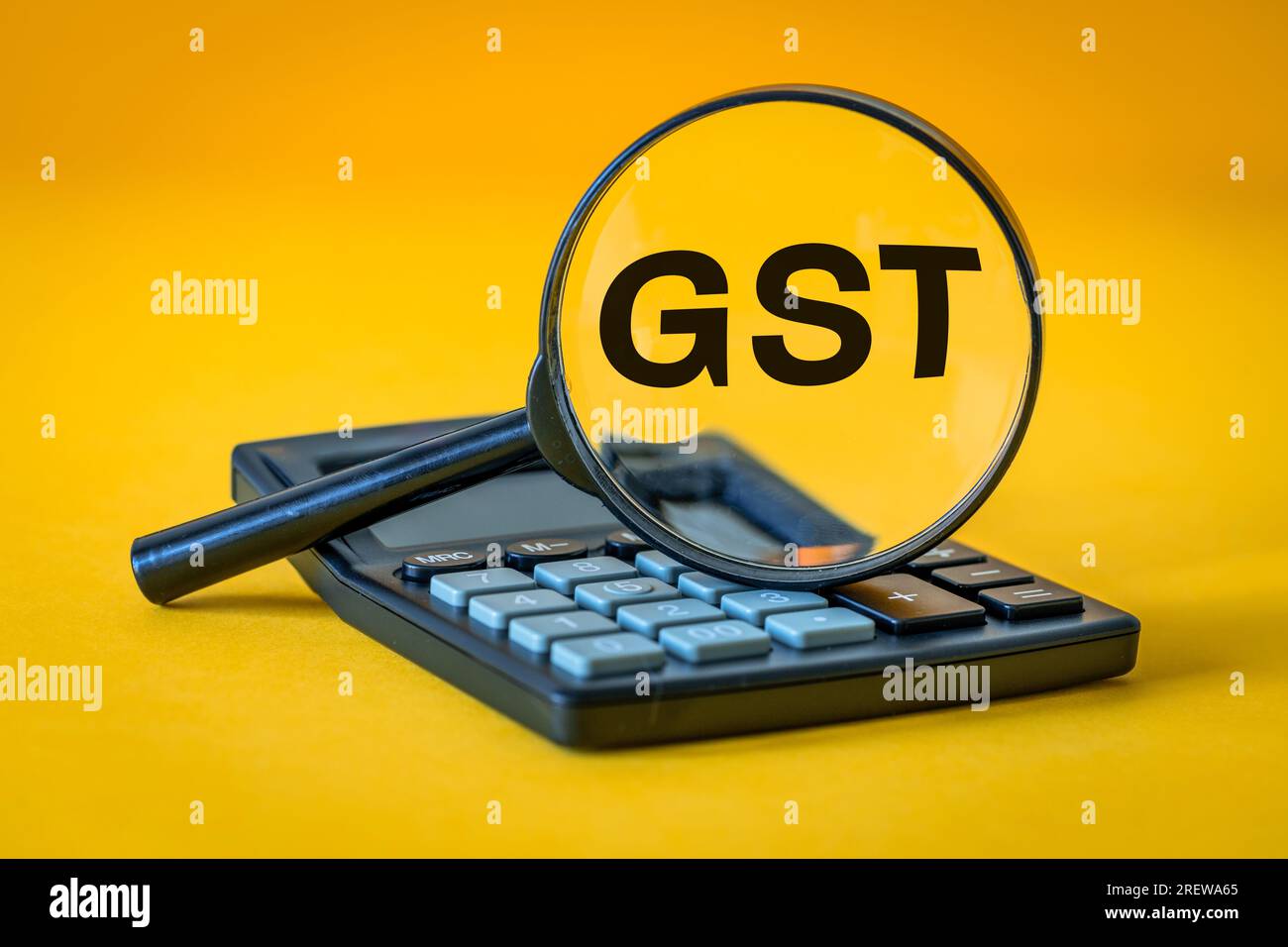 Black calculator and magnifying glass GST text, Beautiful yellow ...