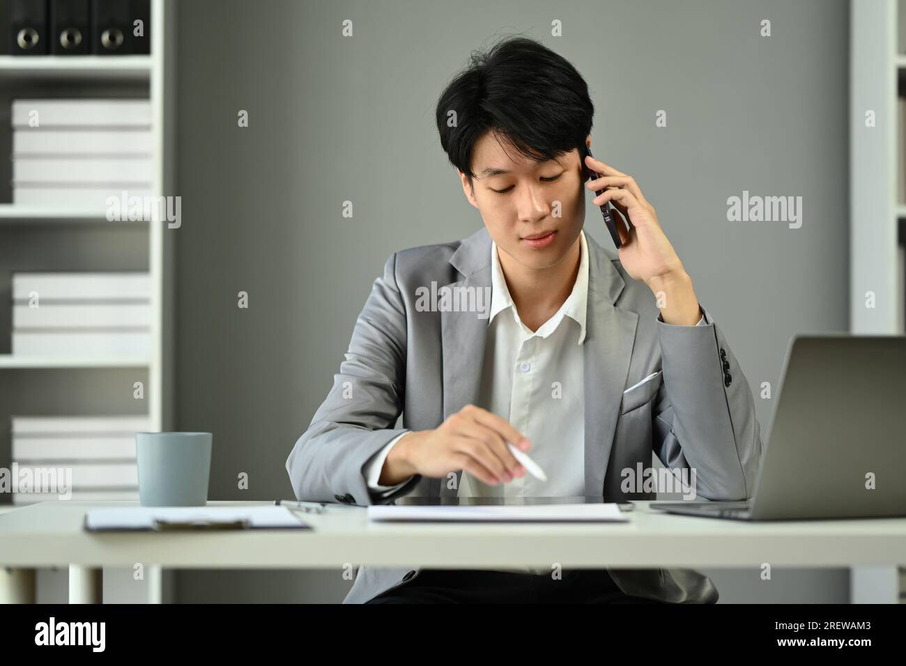 Image of Asian male financial advisor consulting client distantly by ...