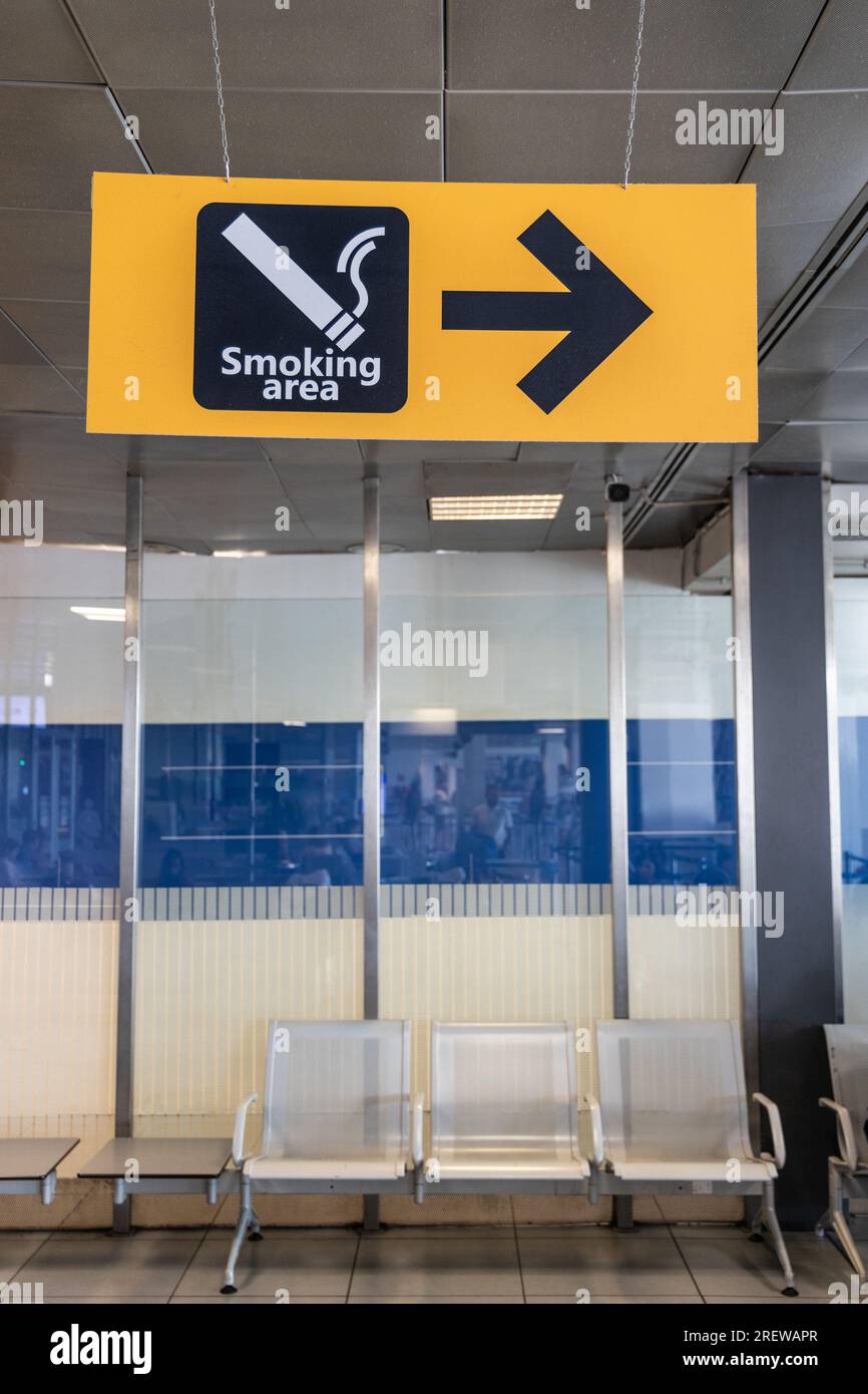 Direction signage to smoking area at airport terminal departure hall ...