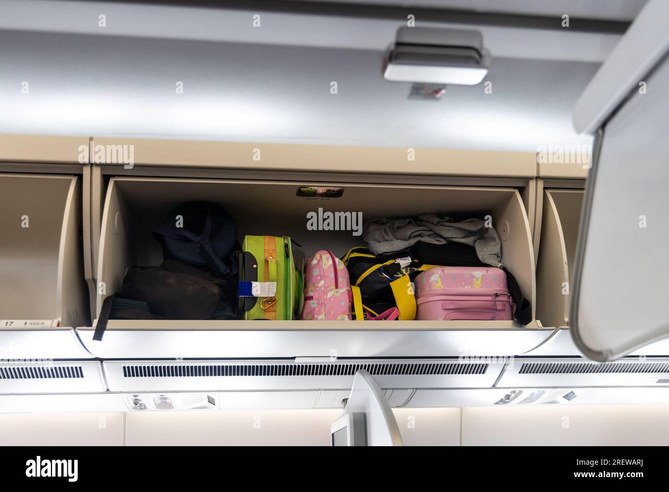 Overhead storage for bags and luggages on airplane cabin Stock Photo ...