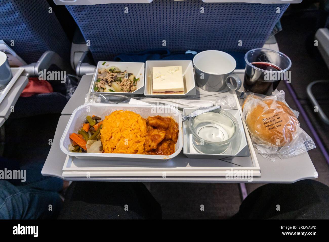 Inflight airplane Asian food set meal served consisting rice and spicy ...