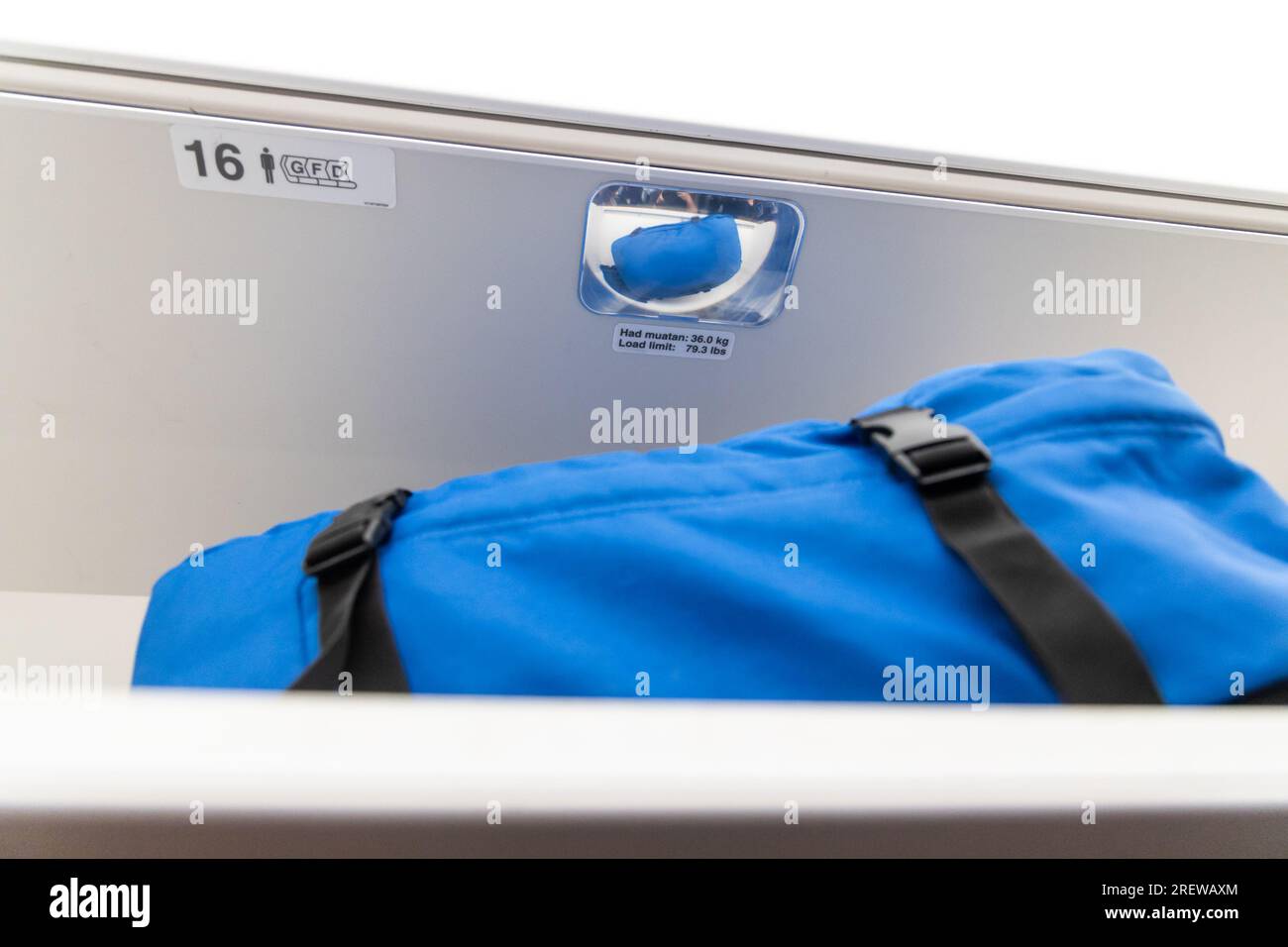 Reflective mirror on overhead luggage storage in airplane cabin for ...