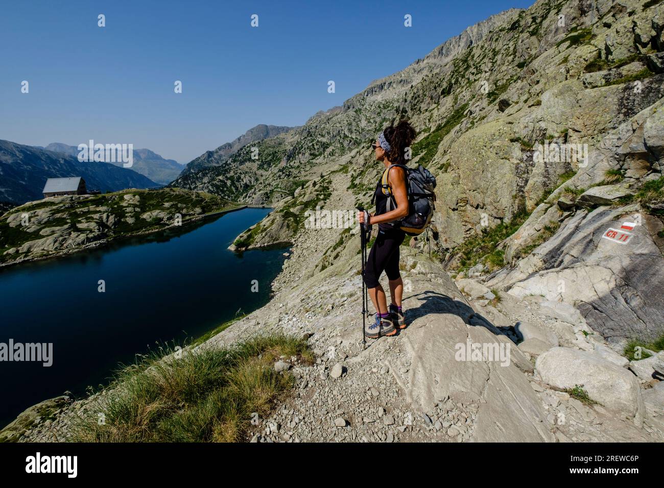 hiker on Bachimaña reservoir, Ibones azules and Bachimaña alto route ...
