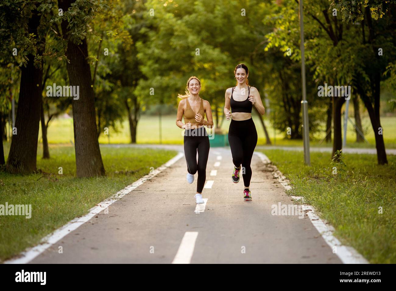 Two young women running in a forest hi-res stock photography and images ...