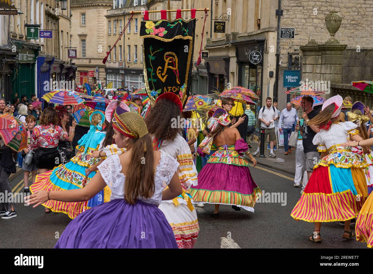 Dancers and musicians dressed in ornate costumes parade through the ...