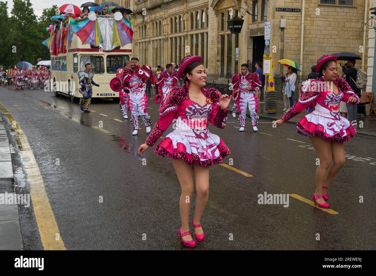 Dancers and musicians dressed in ornate costumes parade through the ...