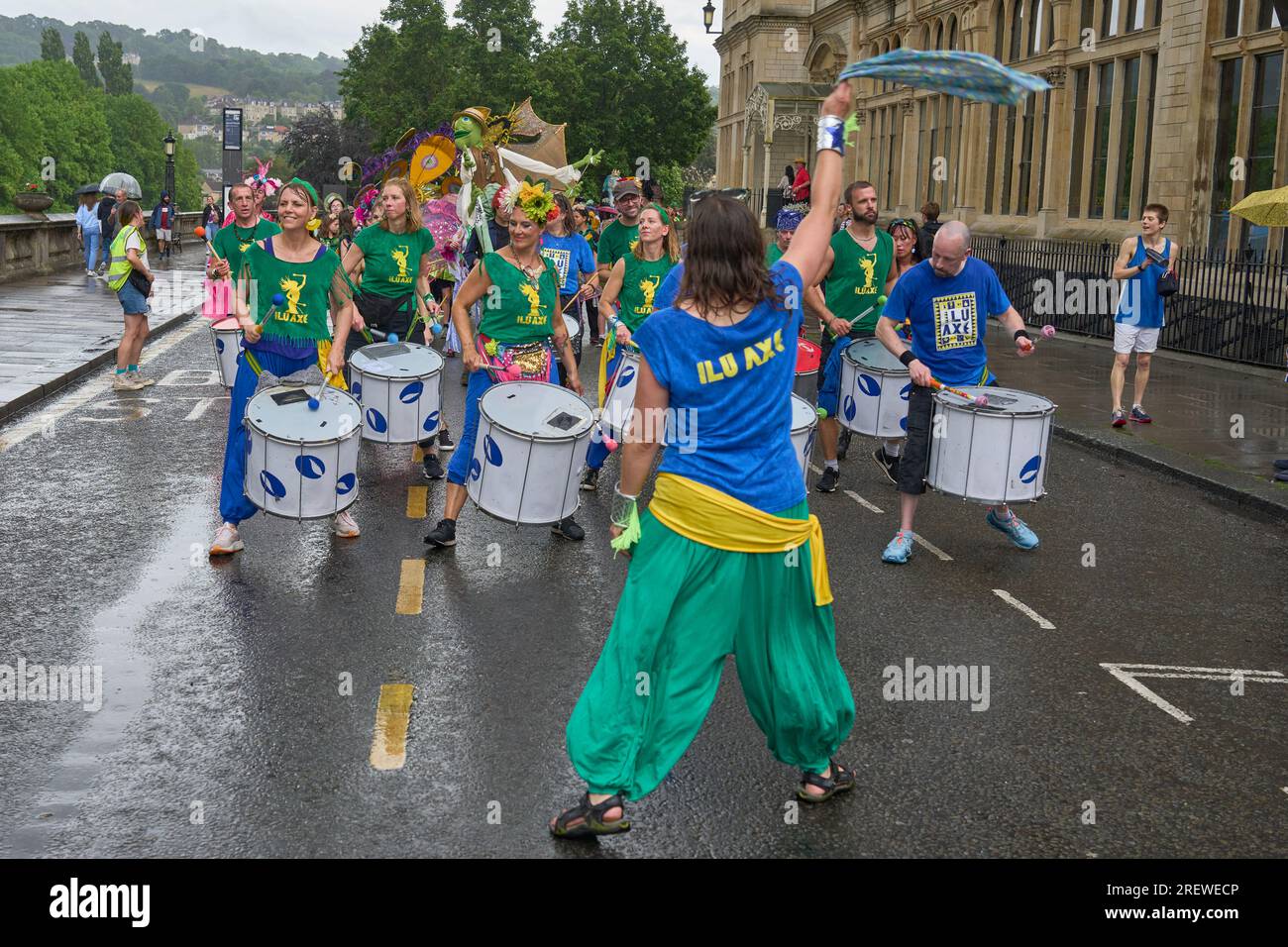 Dancers and musicians dressed in ornate costumes parade through the ...
