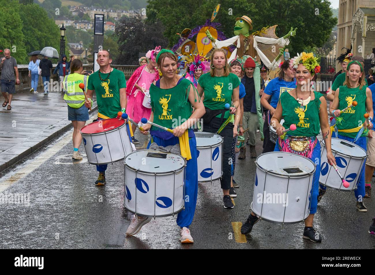 Dancers and musicians dressed in ornate costumes parade through the ...
