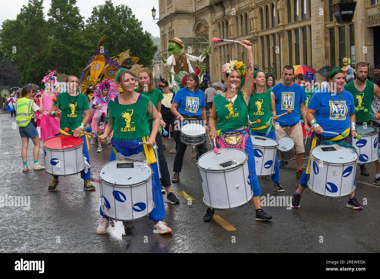 Dancers and musicians dressed in ornate costumes parade through the ...