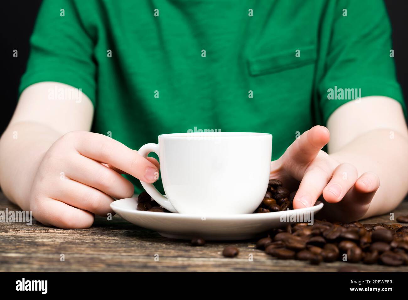 boy drinking tea, coffee beans are lying next to him, a child with food ...