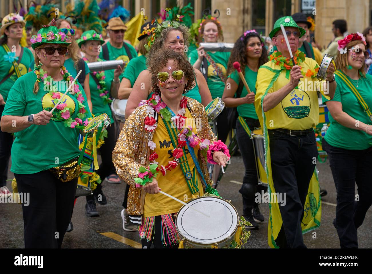 Dancers and musicians dressed in ornate costumes parade through the ...