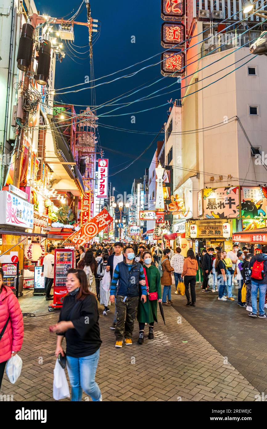 Crowds of tourists walking through the popular Dotonbori street in ...