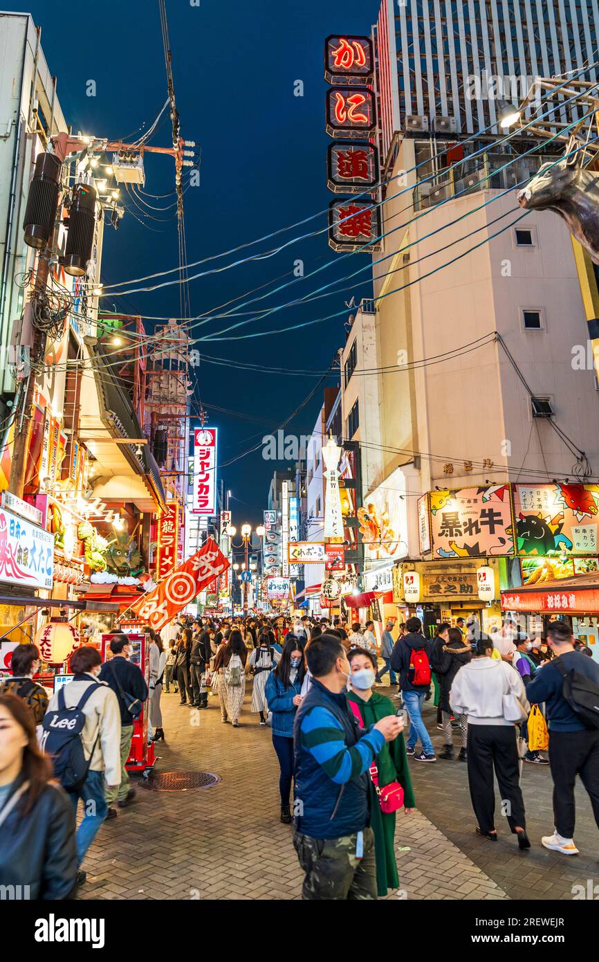 Crowds of tourists walking through the popular Dotonbori street in ...
