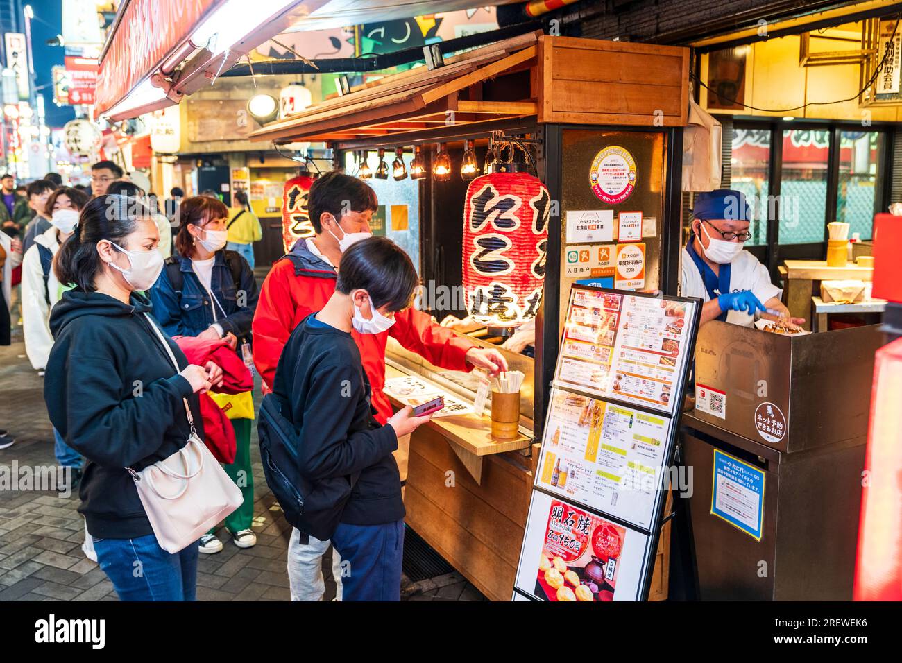 Japanese people waiting in the evening at the take-away counter of the ...