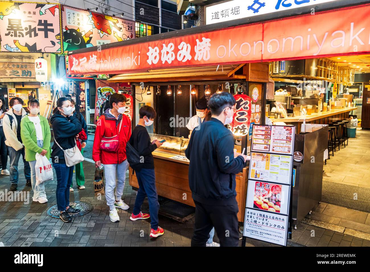 Japanese people waiting in the evening at the take-away counter of the ...