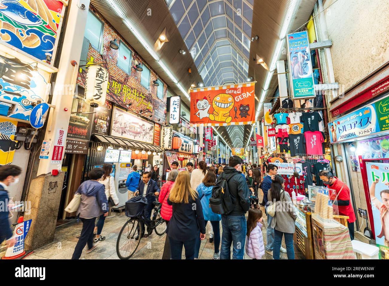 The covered shopping arcade, Sennichimae, busy with people, in the evening. It exits into ...