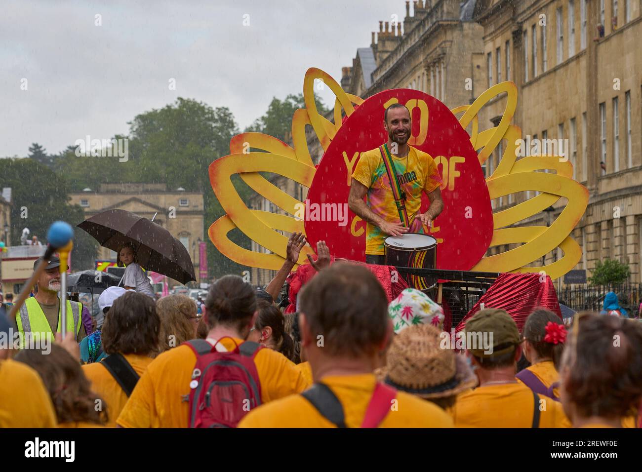Dancers and musicians dressed in ornate costumes parade through the ...