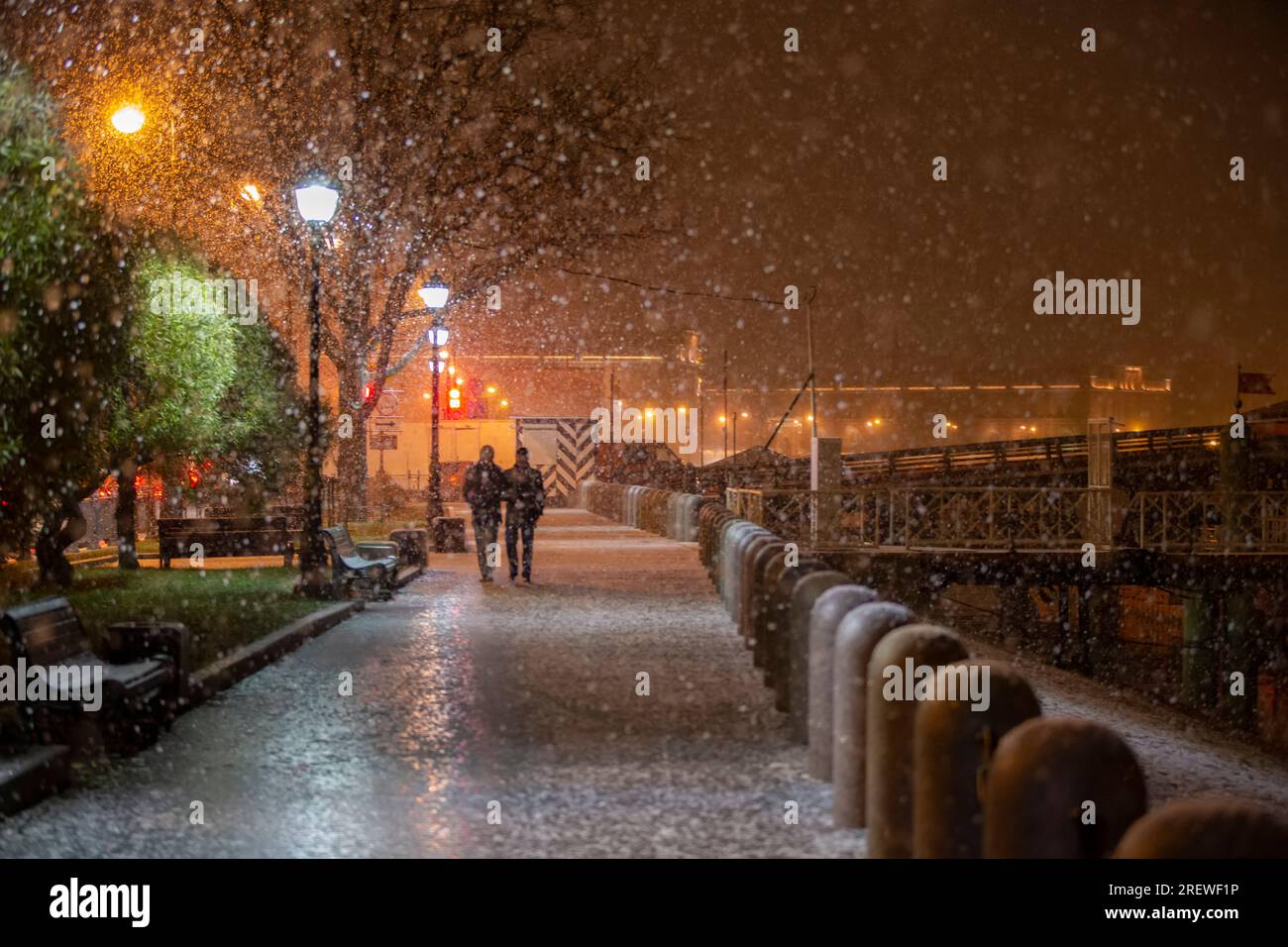 Snow-covered background of the night city with random passers-by Stock ...