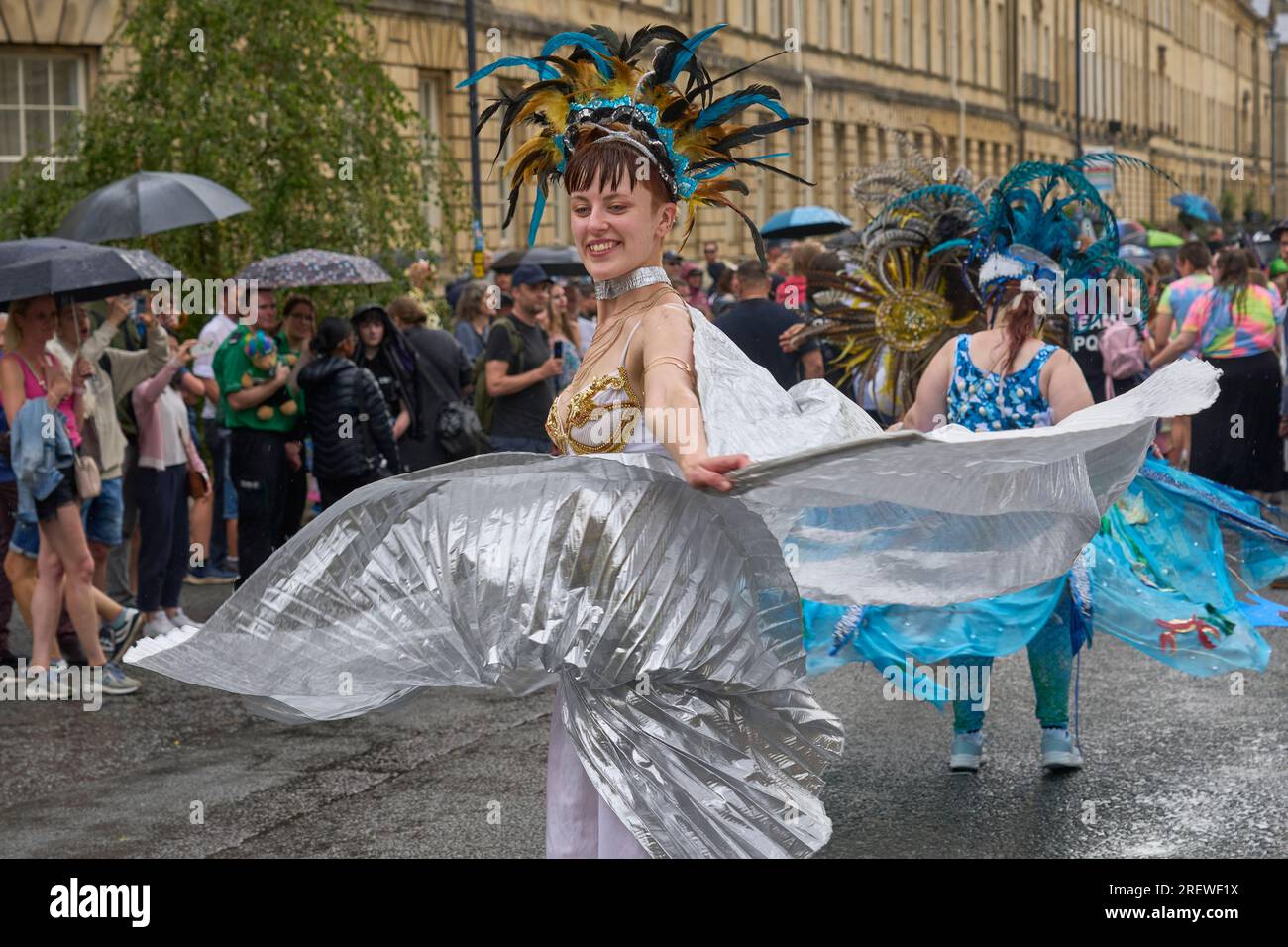 Dancers and musicians dressed in ornate costumes parade through the ...