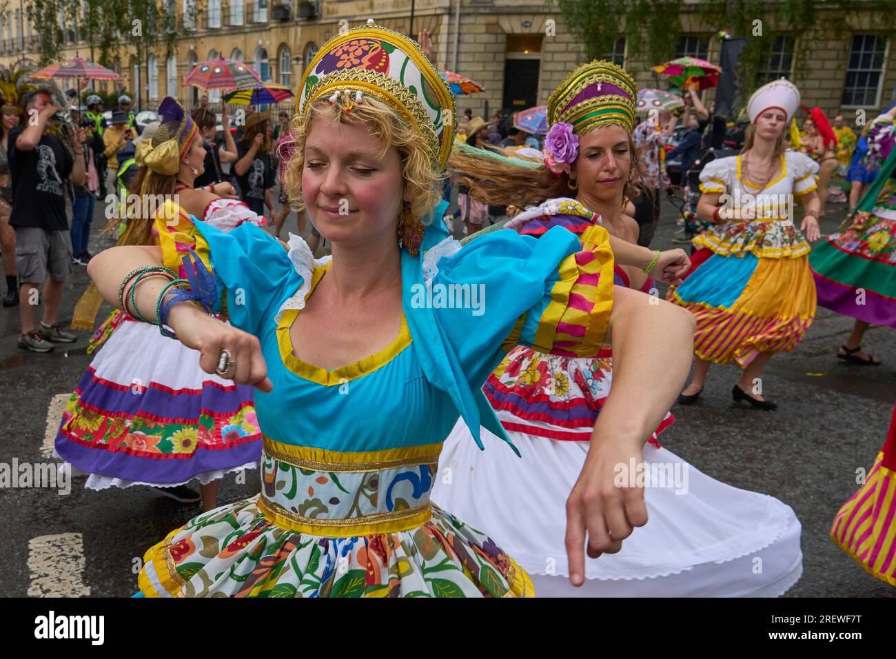 Dancers and musicians dressed in ornate costumes parade through the ...
