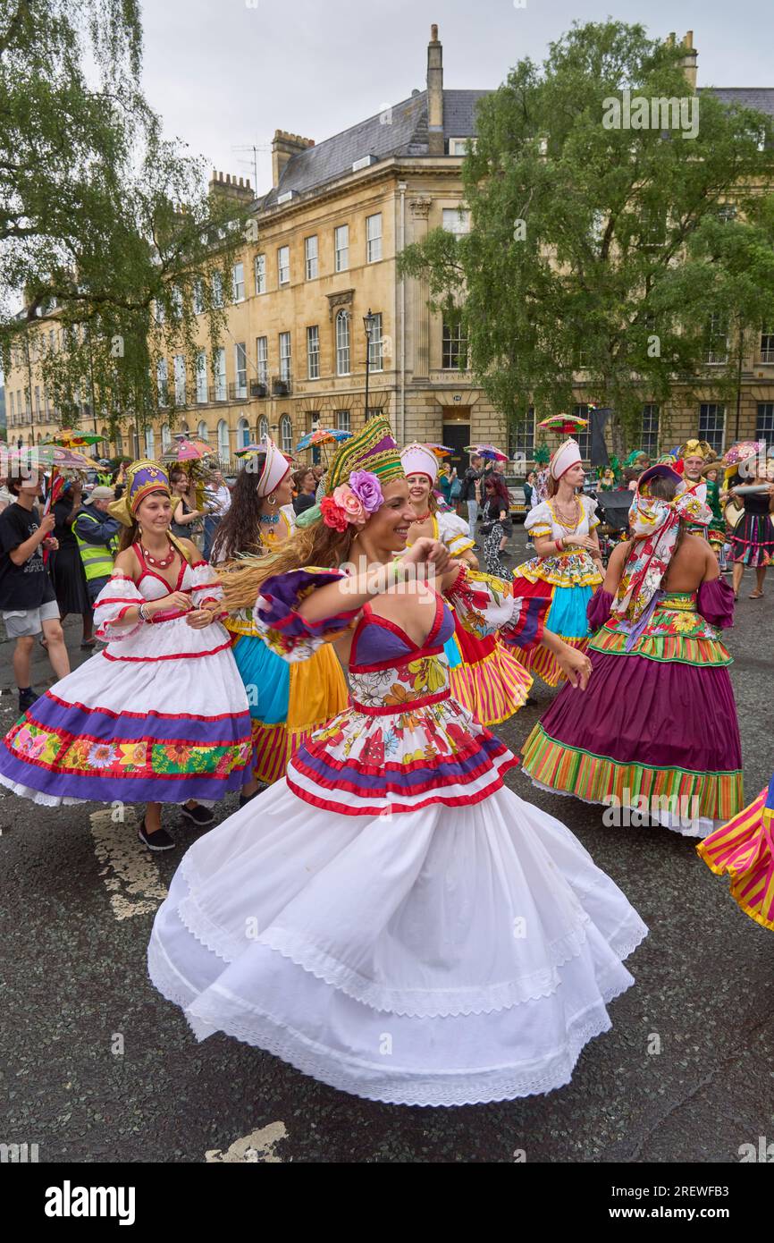 Dancers and musicians dressed in ornate costumes parade through the ...