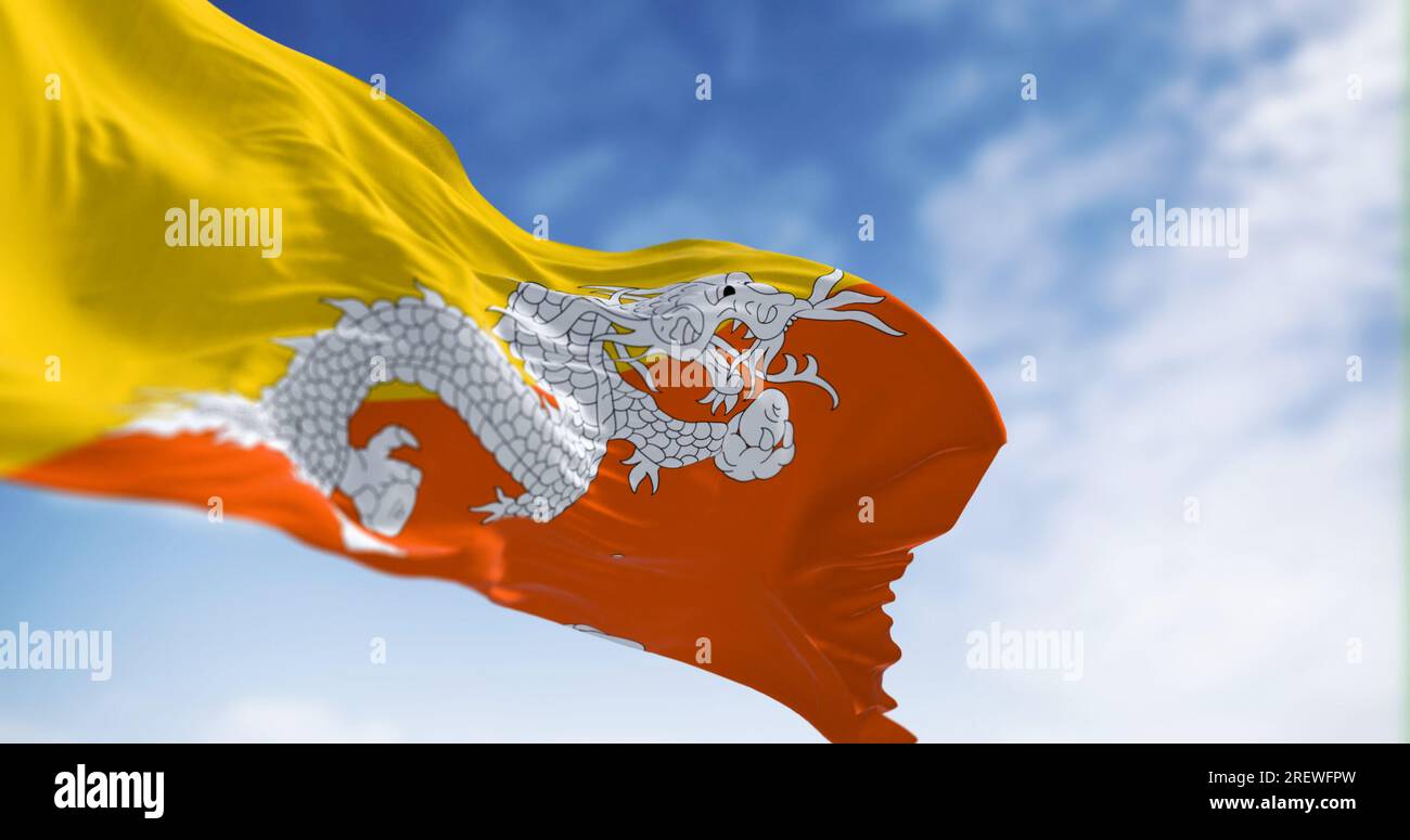 National flag of Bhutan waving in the wind on a clear day. Yellow upper ...