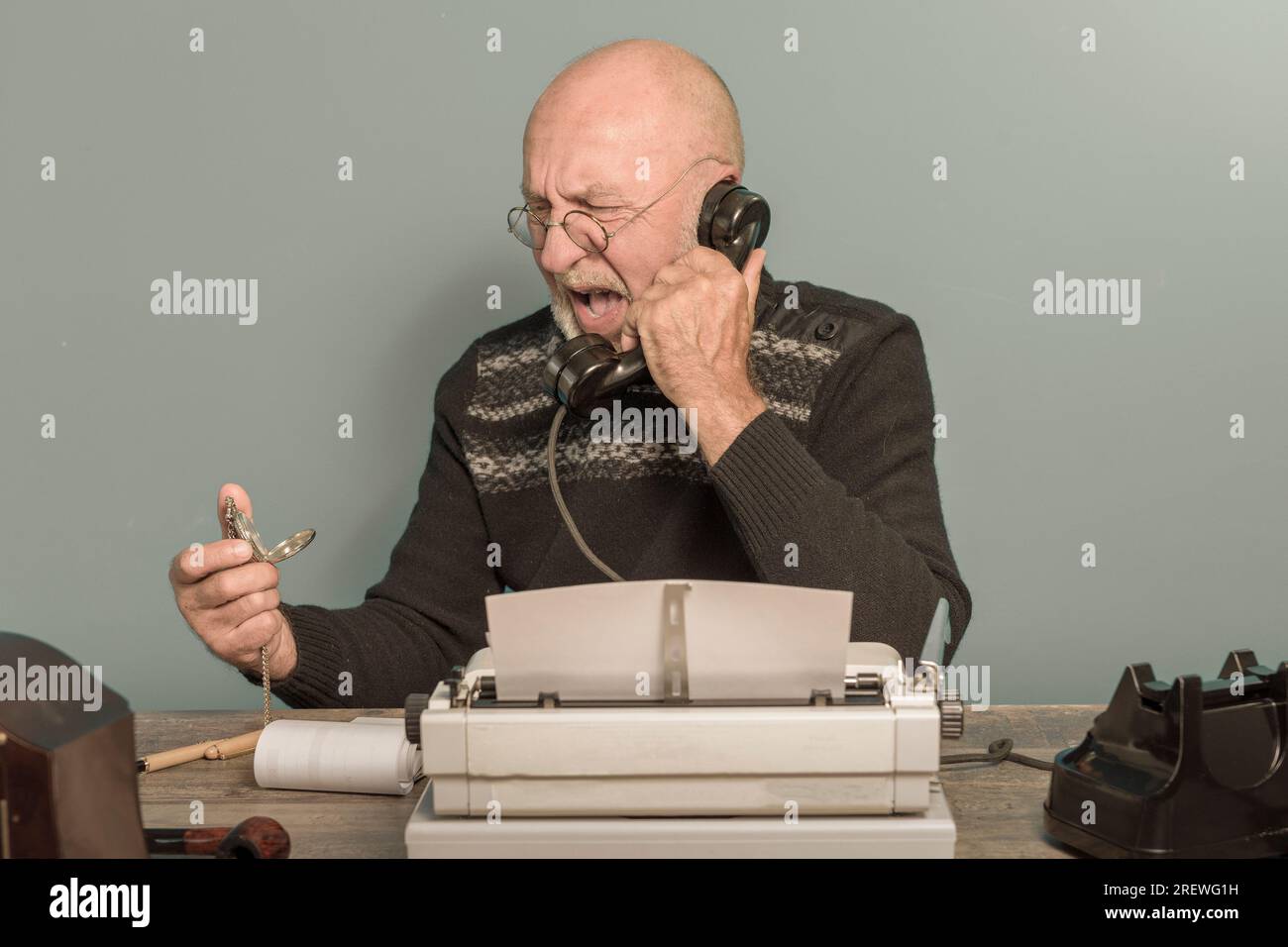 Journalist from the past at work. Desk with telephone and typewriter ...