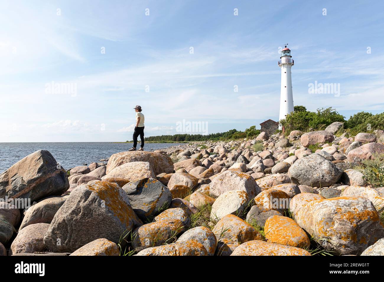Teenager tourist exploring the rocky coast near the beautiful kihnu ...