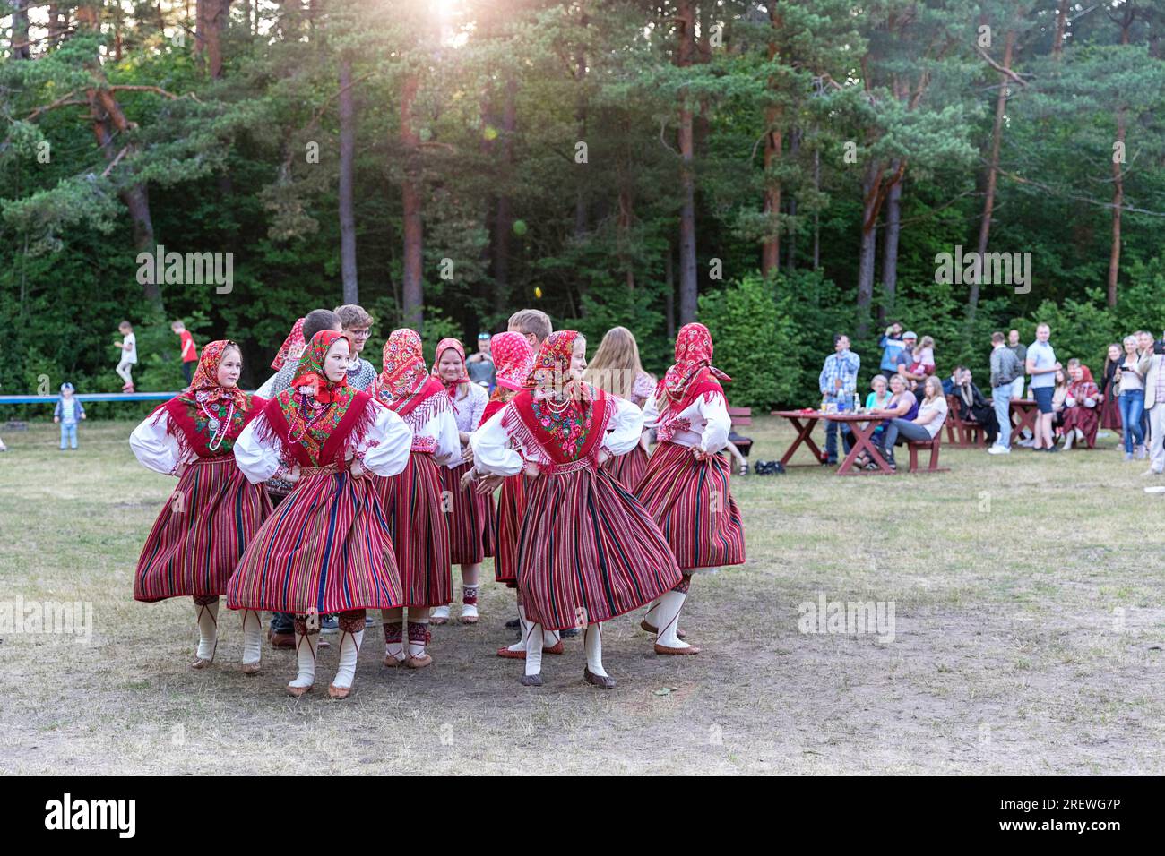 Women in traditional folk costumes dancing and celebrating Jaanipaeva ...