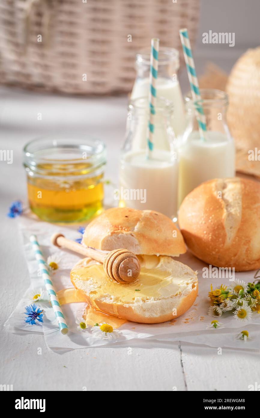 Homemade and sweet wheat buns for lunch. Breakfast with milk and honey ...