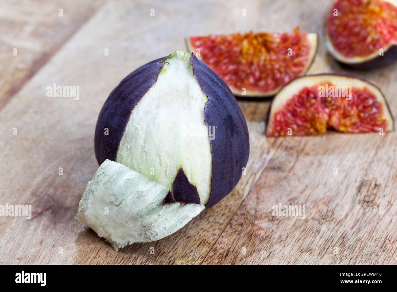 healthy red delicious fig pulp with seeds, ripe figs cut into pieces, close up ripe fruit in the ...