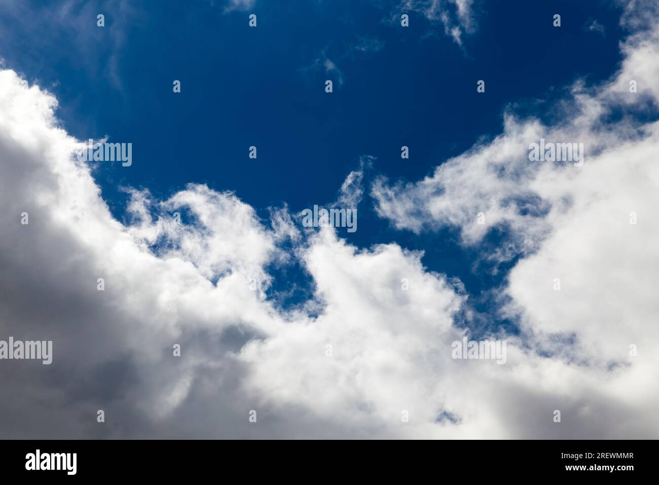 a real blue sky with lots of clouds in the sunny time of the day ...