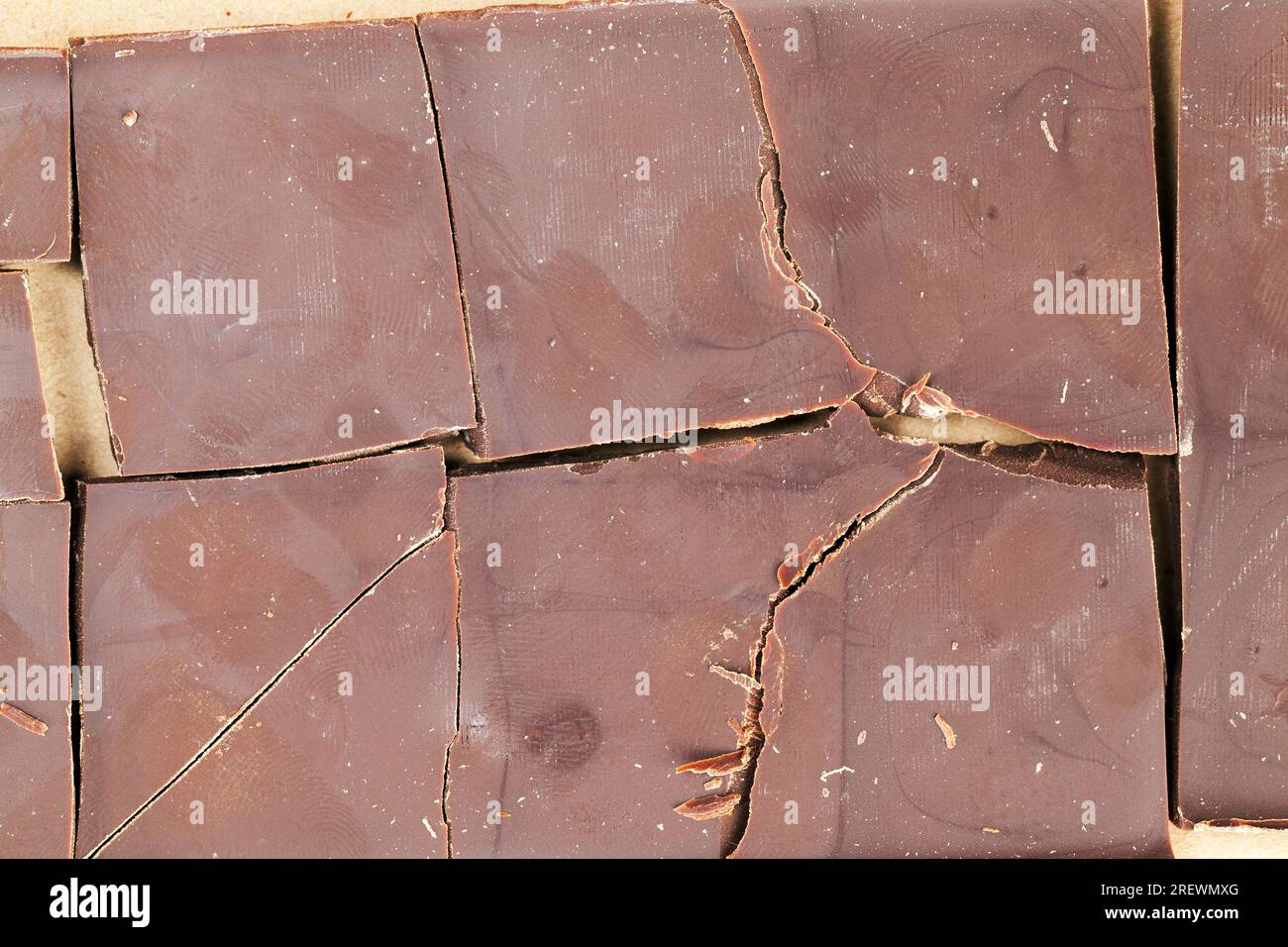 chocolate sweetness in paper packaging, broken milk chocolate bar made ...