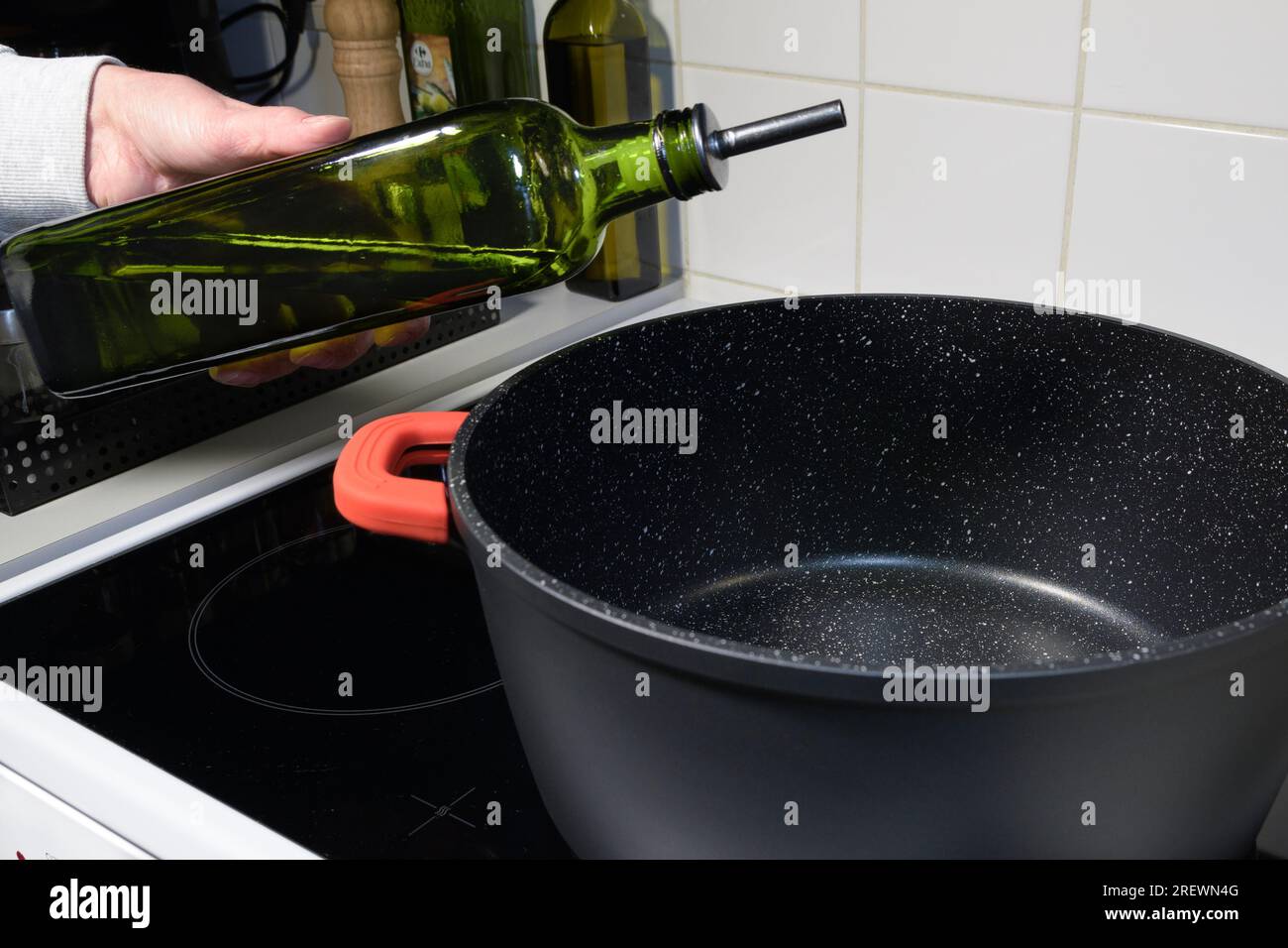 Pouring vegetable oil into a stockpot on the stove for cooking Stock ...