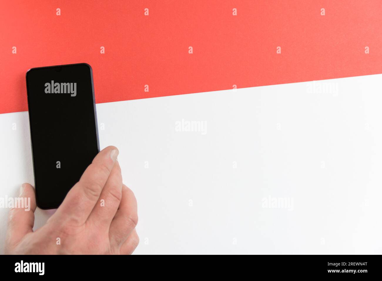 Red line. Hand with smartphone on red and white background Stock Photo ...